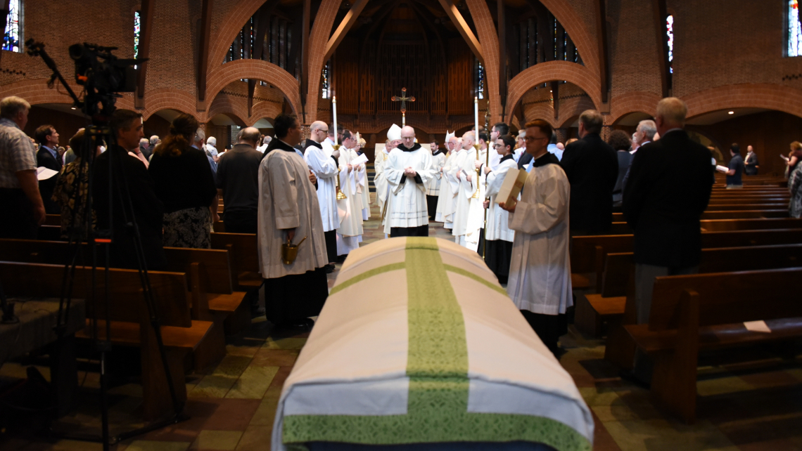 During a Mass of Christian Burial, Bishop Joseph Gerry, OSB, is ...